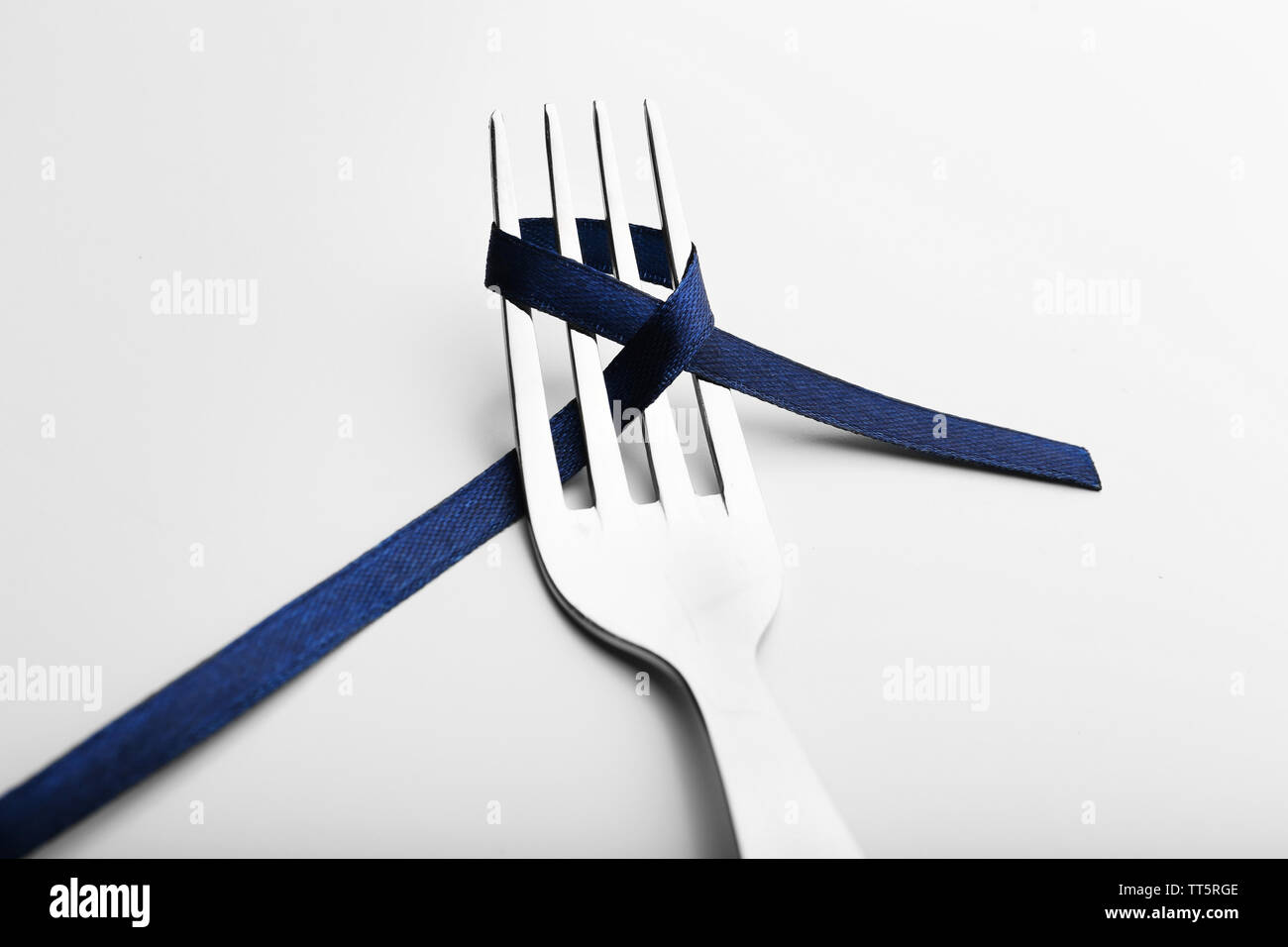 Stages of tying bow on fork close-up Stock Photo - Alamy