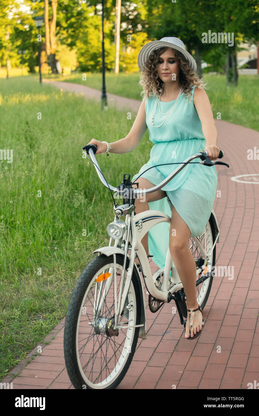 pretty woman biker on bicycle riding in park smiling Stock Photo - Alamy