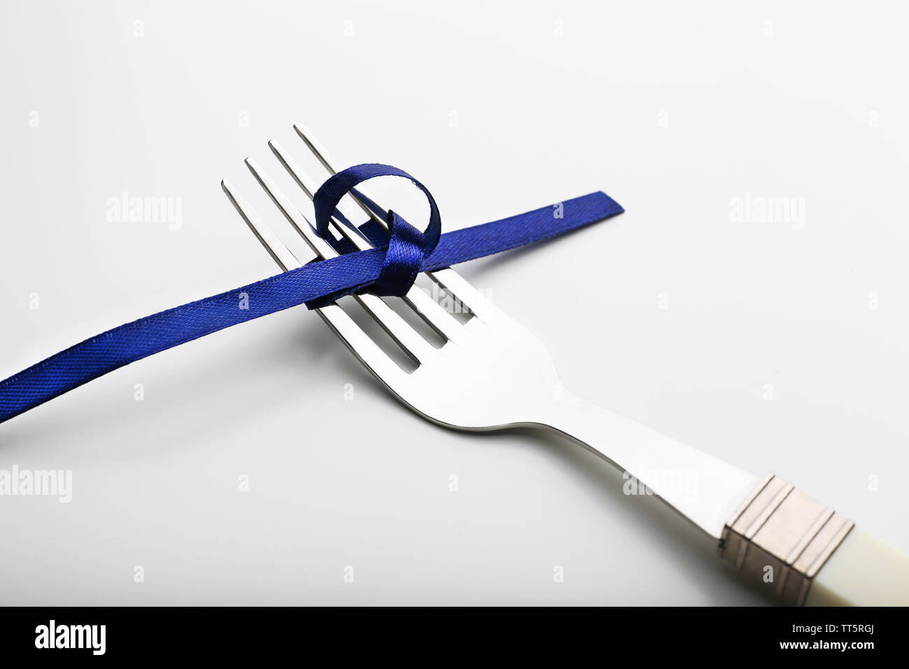 Stages of tying bow on fork close-up Stock Photo - Alamy