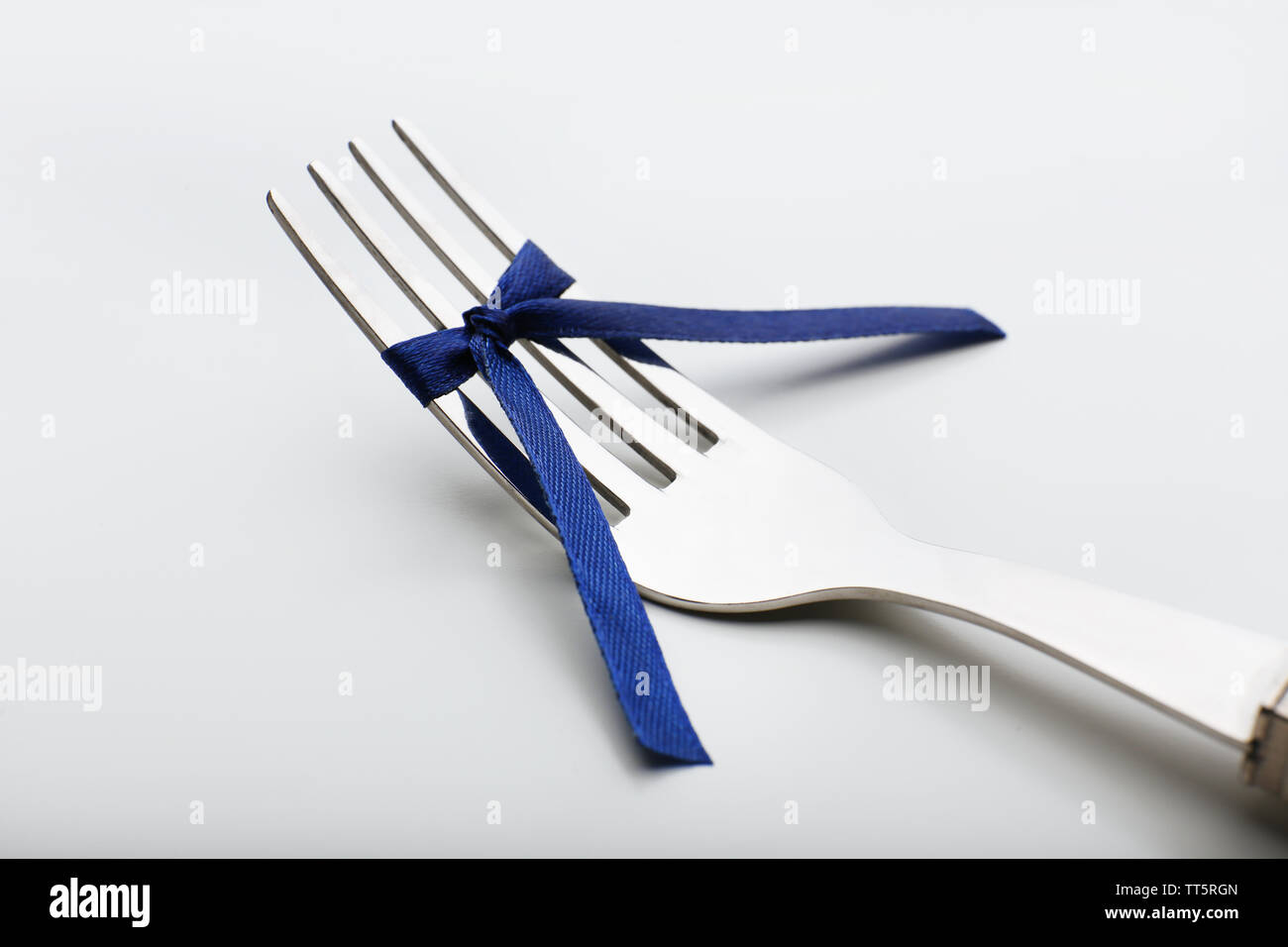 Stages of tying bow on fork close-up Stock Photo - Alamy