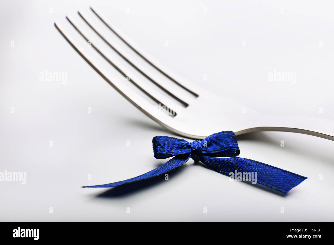 Stages of tying bow on fork close-up Stock Photo - Alamy