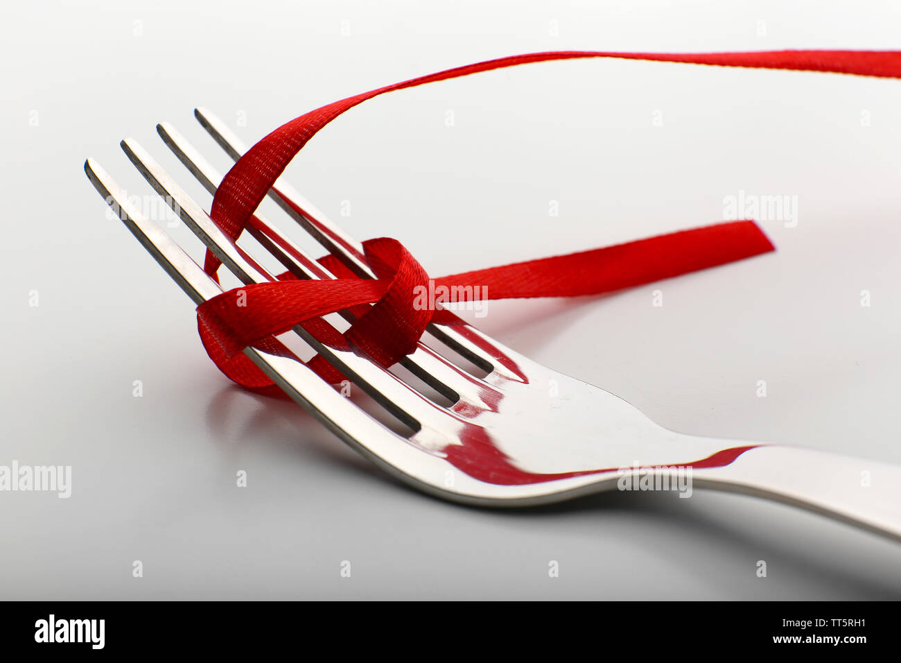 Stages of tying bow on fork, close-up Stock Photo - Alamy