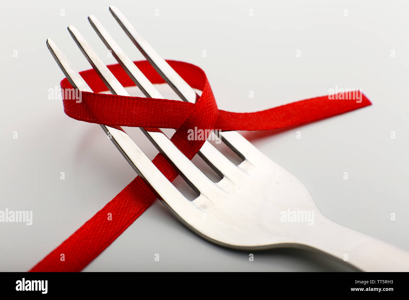 Stages of tying bow on fork, close-up Stock Photo - Alamy