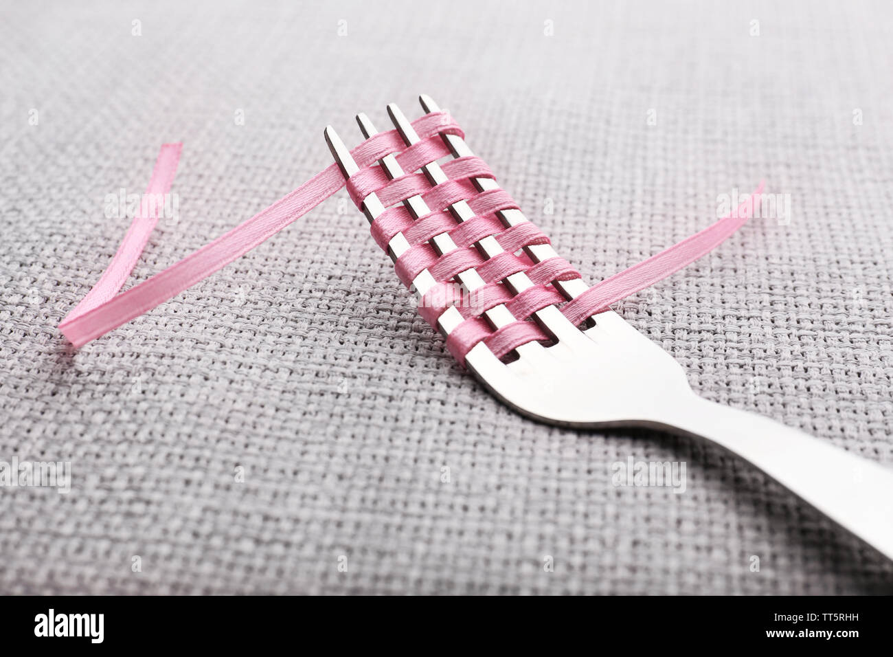 Stages of tying bow on fork, close-up Stock Photo - Alamy