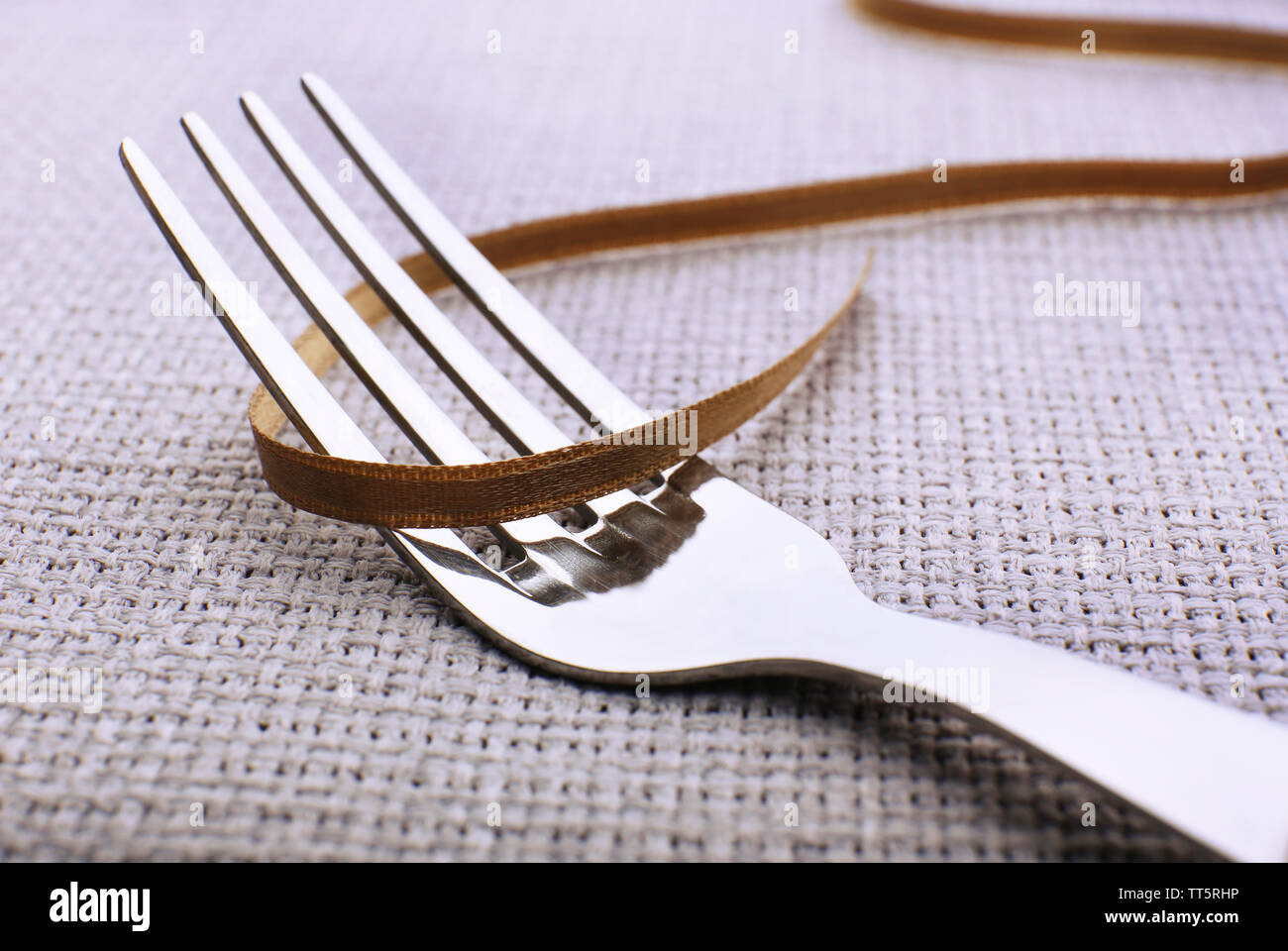 Stages of tying bow on fork, close-up Stock Photo - Alamy