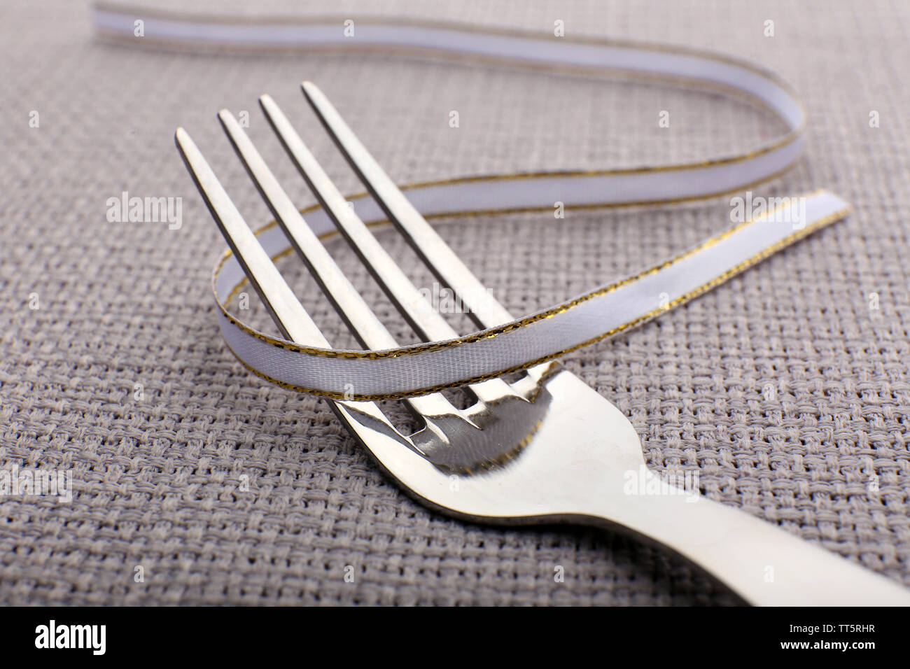 Stages of tying bow on fork, close-up Stock Photo - Alamy