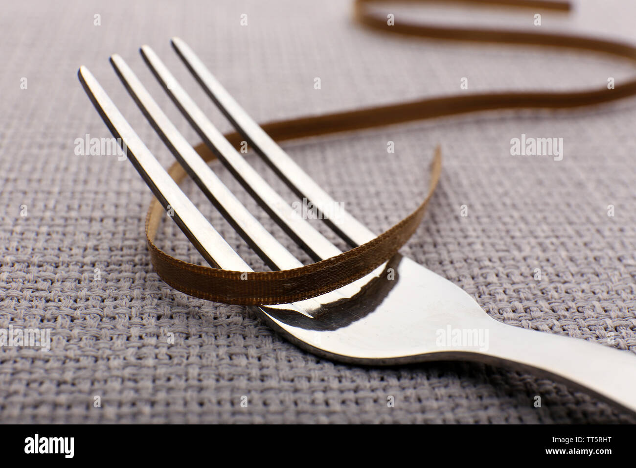 Stages of tying bow on fork, close-up Stock Photo - Alamy