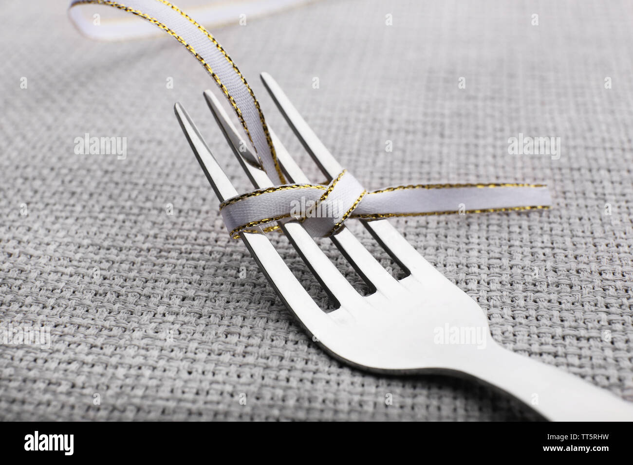 Stages of tying bow on fork, close-up Stock Photo - Alamy