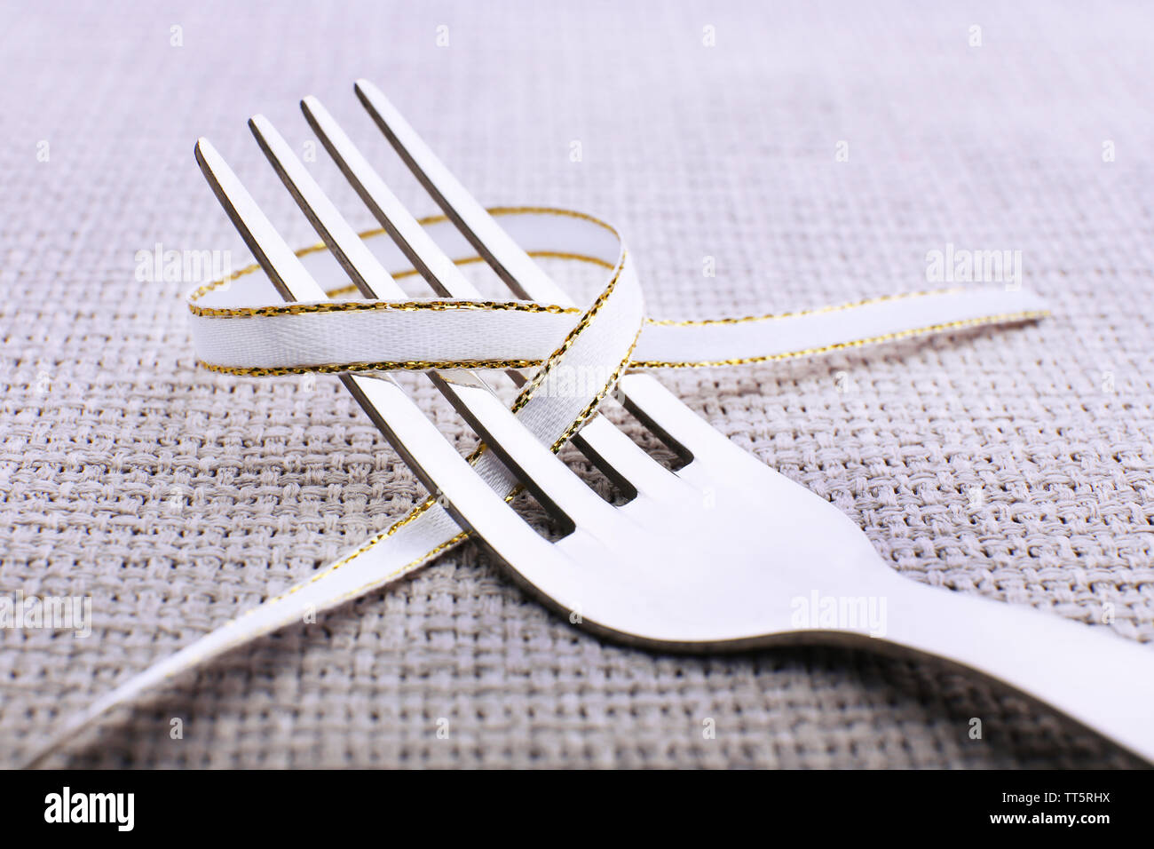 Stages of tying bow on fork, close-up Stock Photo - Alamy