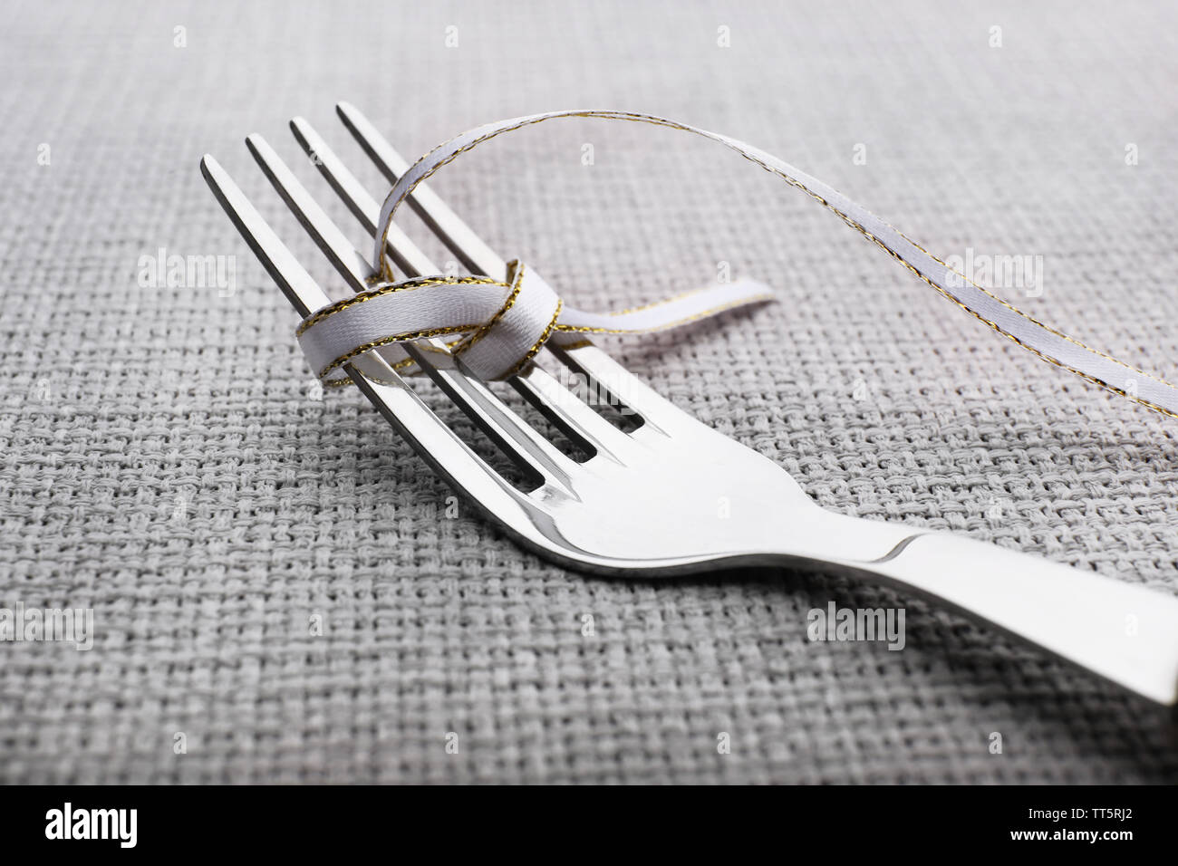 Stages of tying bow on fork, close-up Stock Photo - Alamy