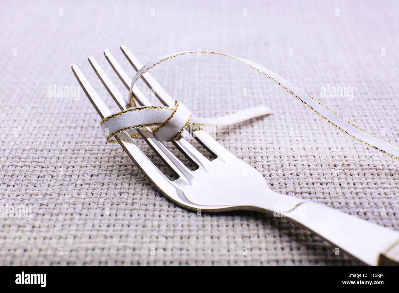 Stages of tying bow on fork, close-up Stock Photo - Alamy