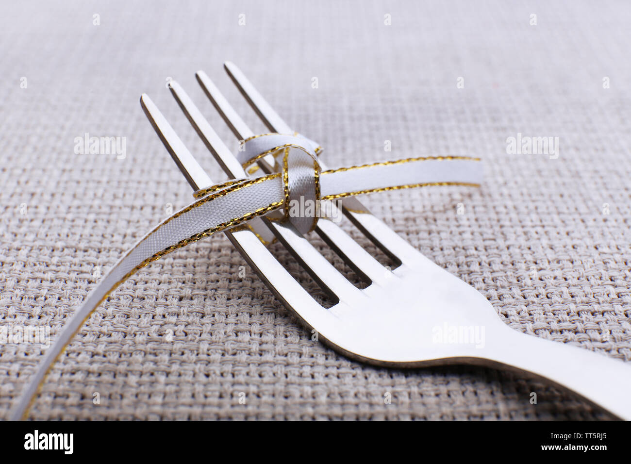 Stages of tying bow on fork, close-up Stock Photo - Alamy