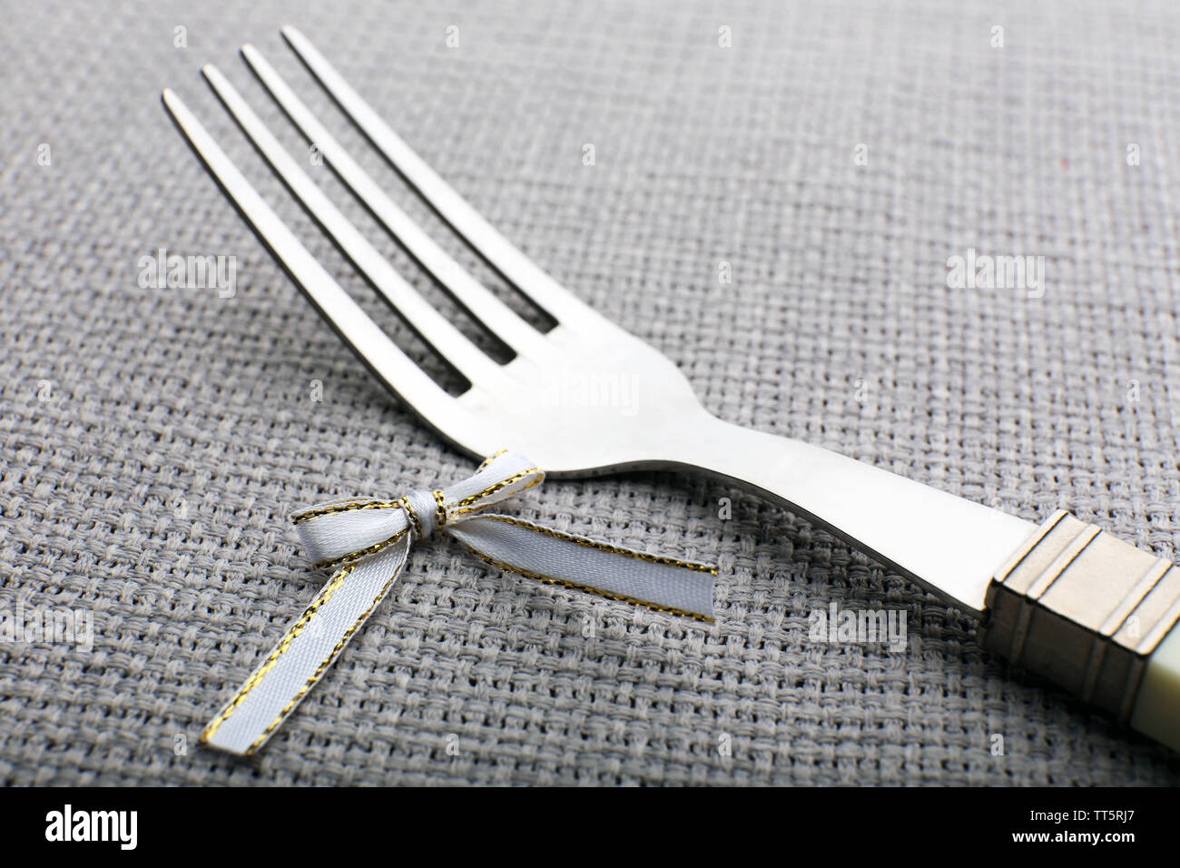 Stages of tying bow on fork, close-up Stock Photo - Alamy