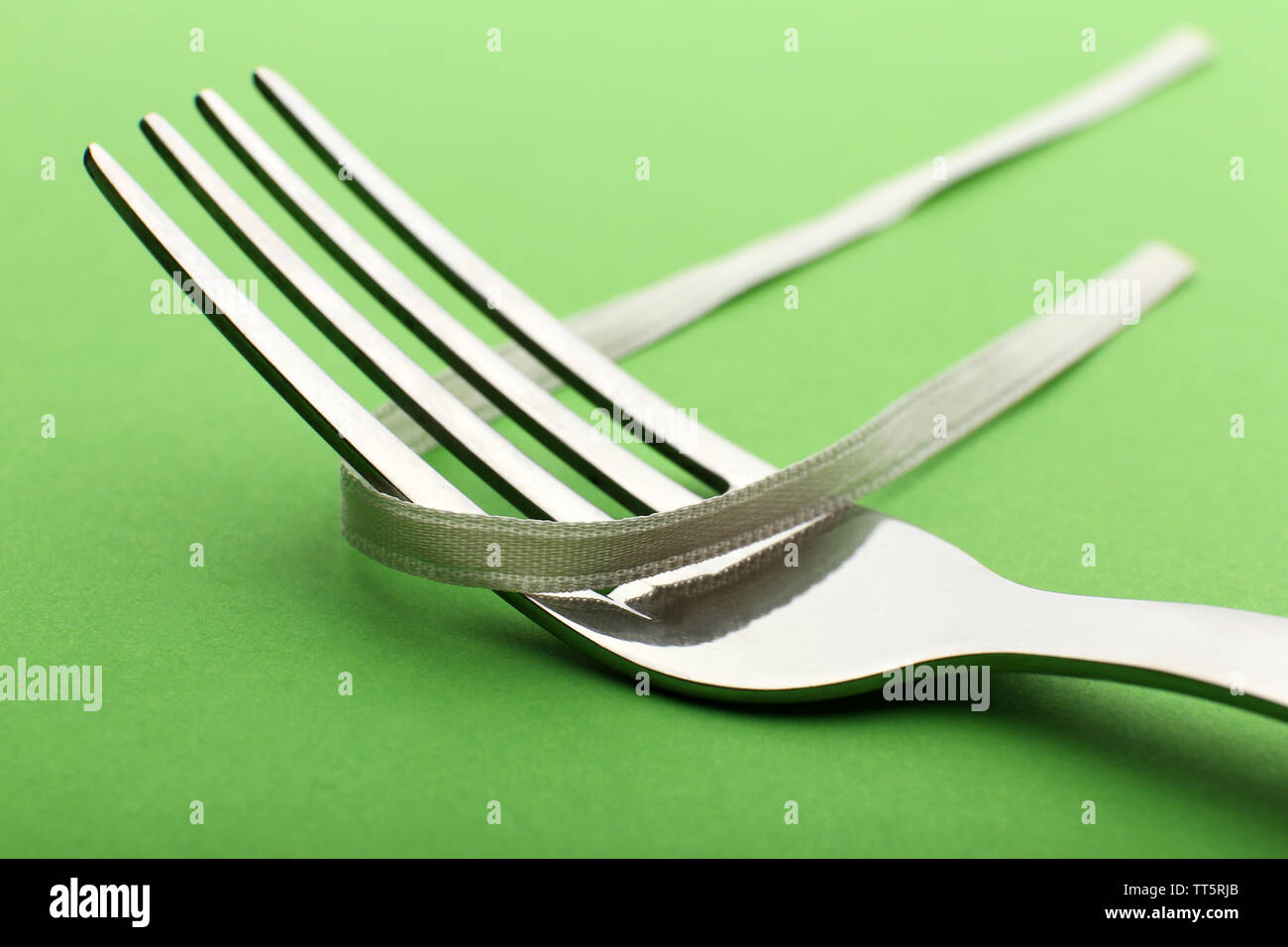 Stages of tying bow on fork on green background, close-up Stock Photo ...