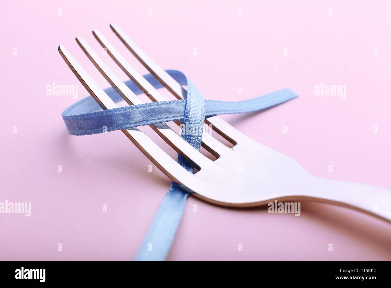 Stages of tying bow on fork, close-up Stock Photo - Alamy