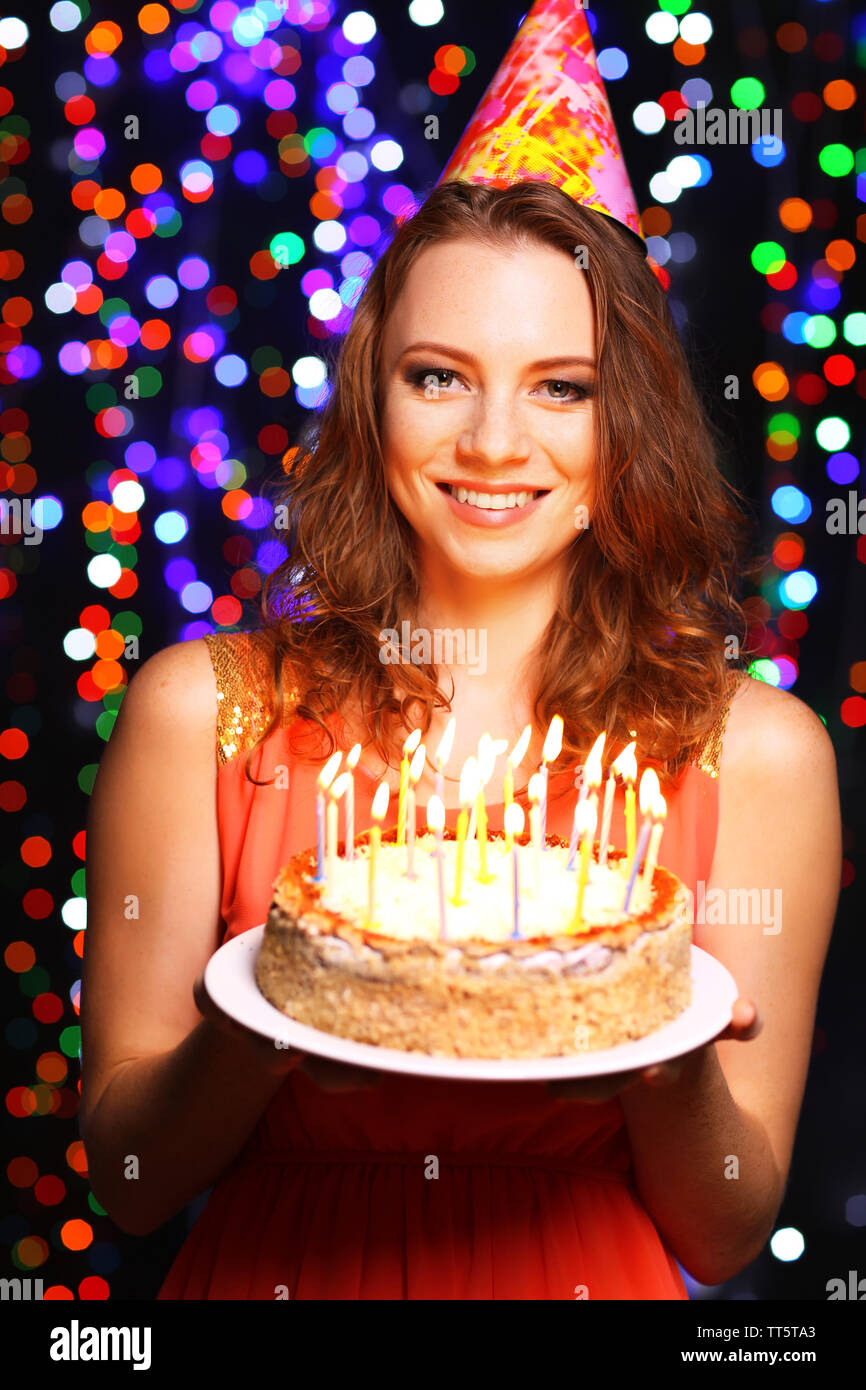 Portrait of beautiful young girl on bright lights background Stock ...