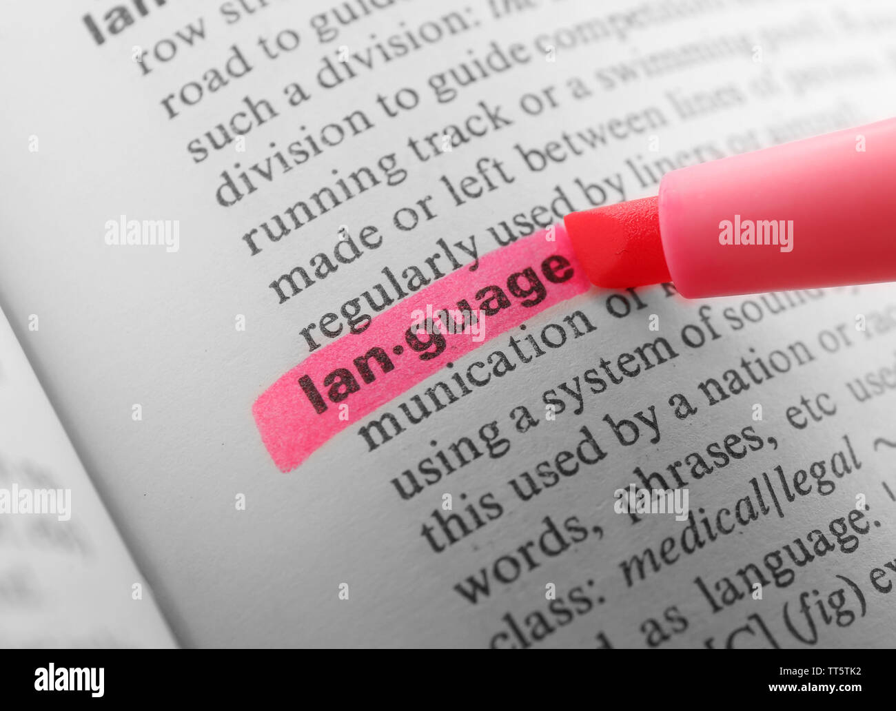Pink marker highlighting word in dictionary Stock Photo - Alamy