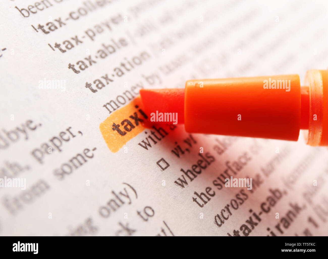 Orange marker highlighting word in dictionary Stock Photo - Alamy