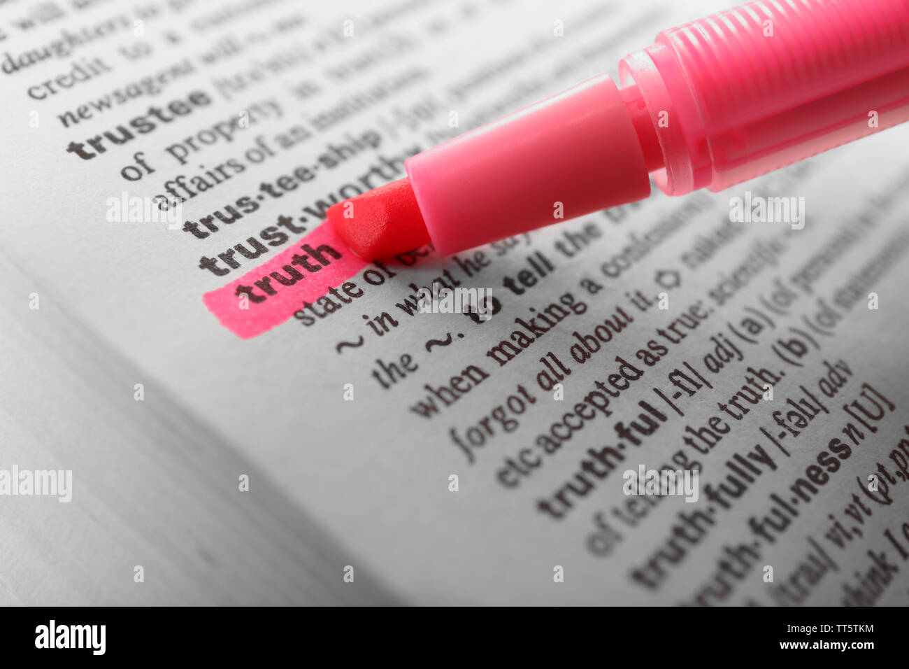 Pink marker highlighting word in dictionary Stock Photo - Alamy