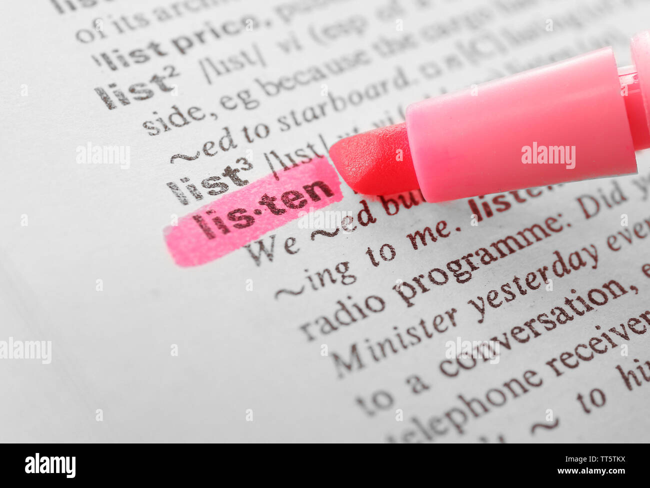Pink marker highlighting word in dictionary Stock Photo - Alamy