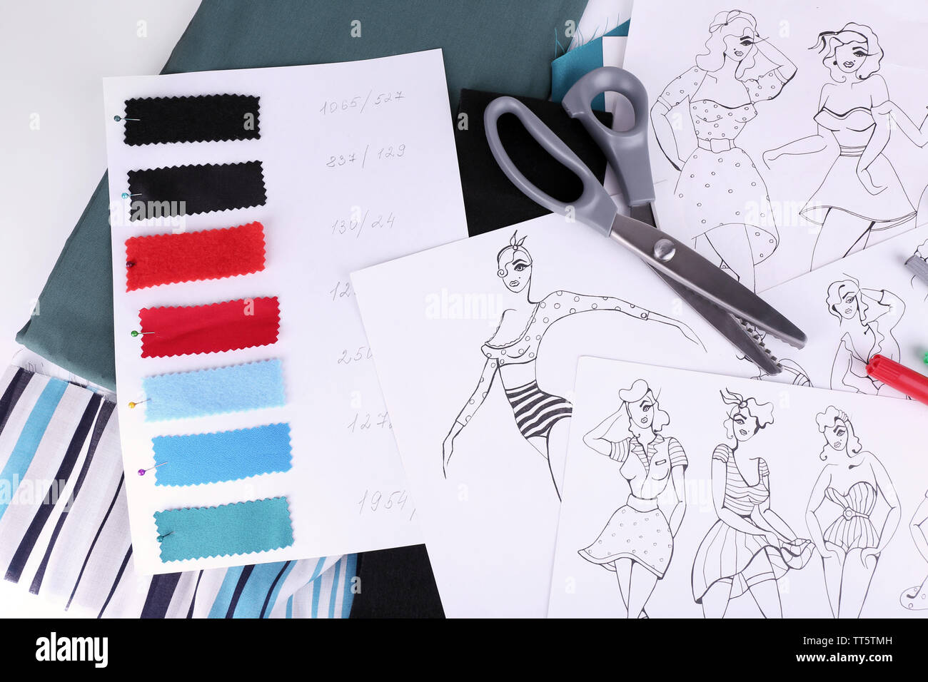 Sketches of clothes and fabric samples on table Stock Photo - Alamy