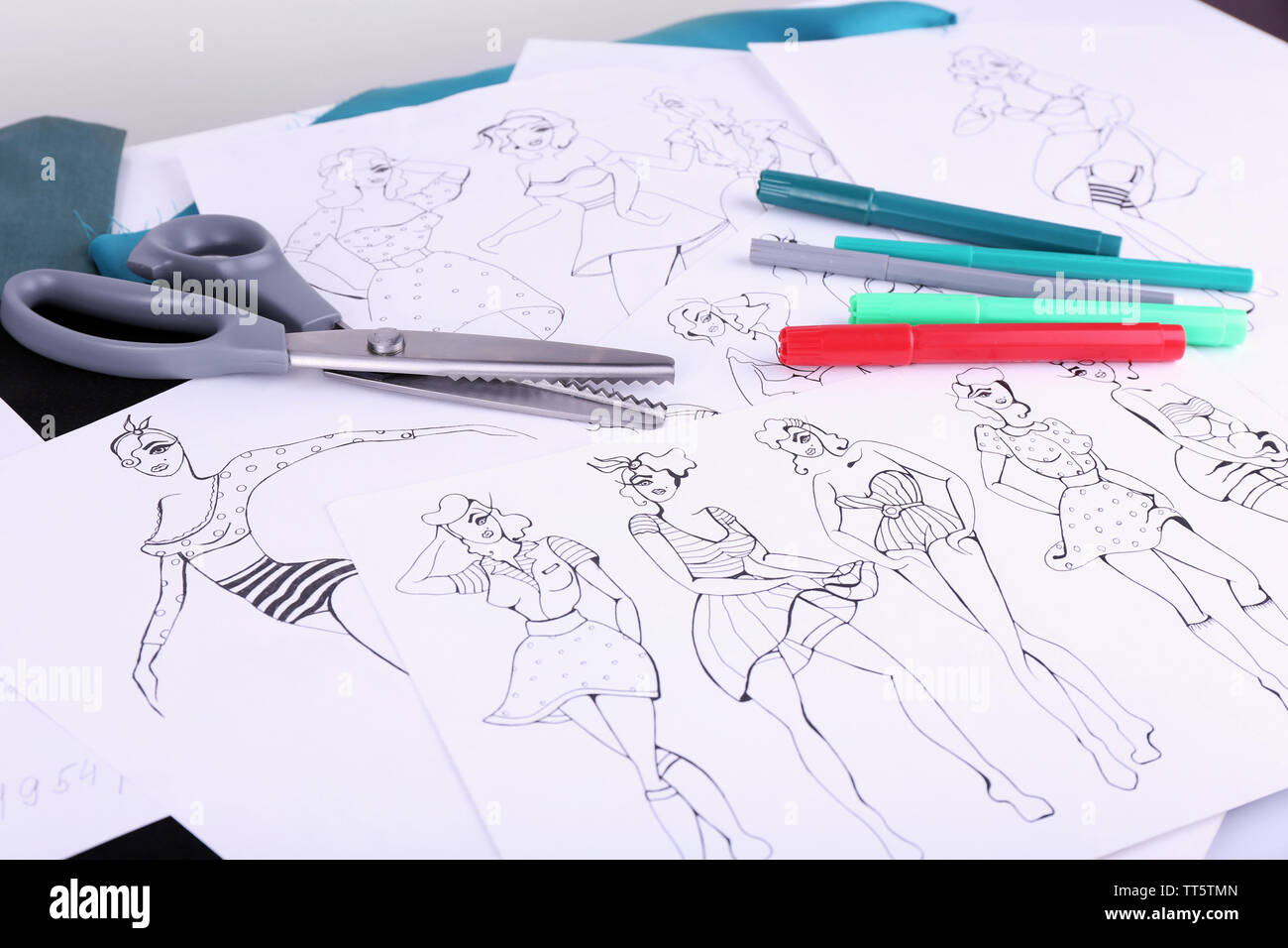 Sketches of clothes on table Stock Photo - Alamy