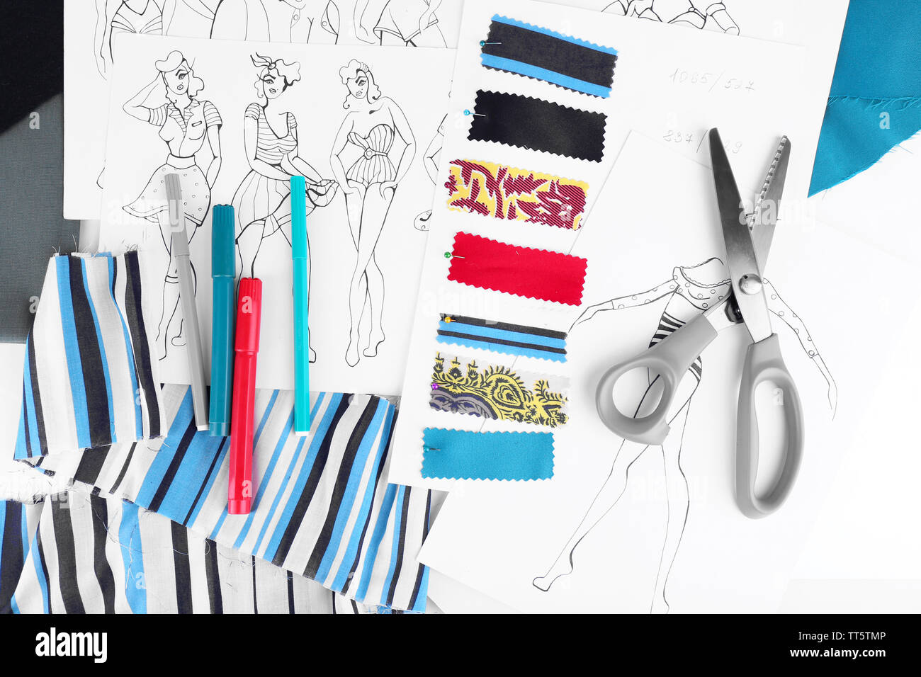 Sketches of clothes and fabric samples on table Stock Photo - Alamy