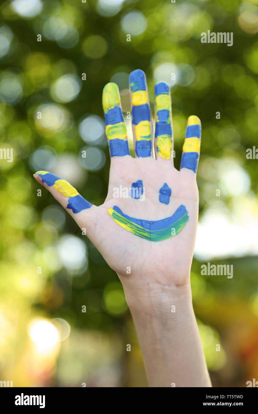 Smiling colorful hand on natural background Stock Photo - Alamy