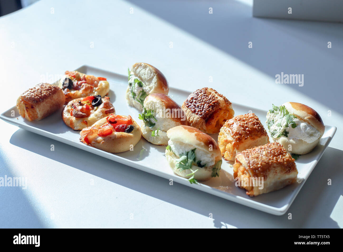 salty and sweet combined snack plate white Stock Photo - Alamy