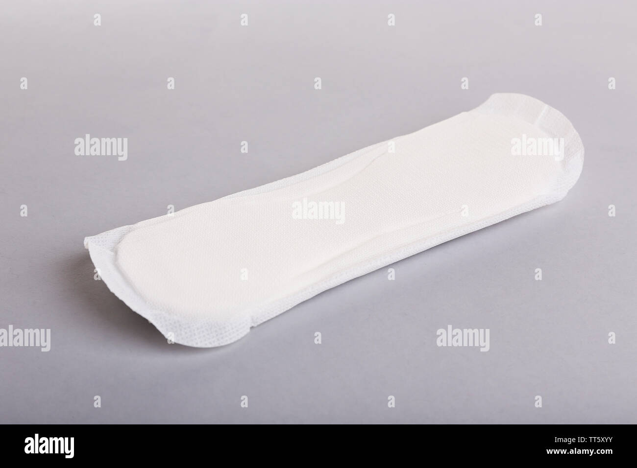 Sanitary pad on light background Stock Photo - Alamy