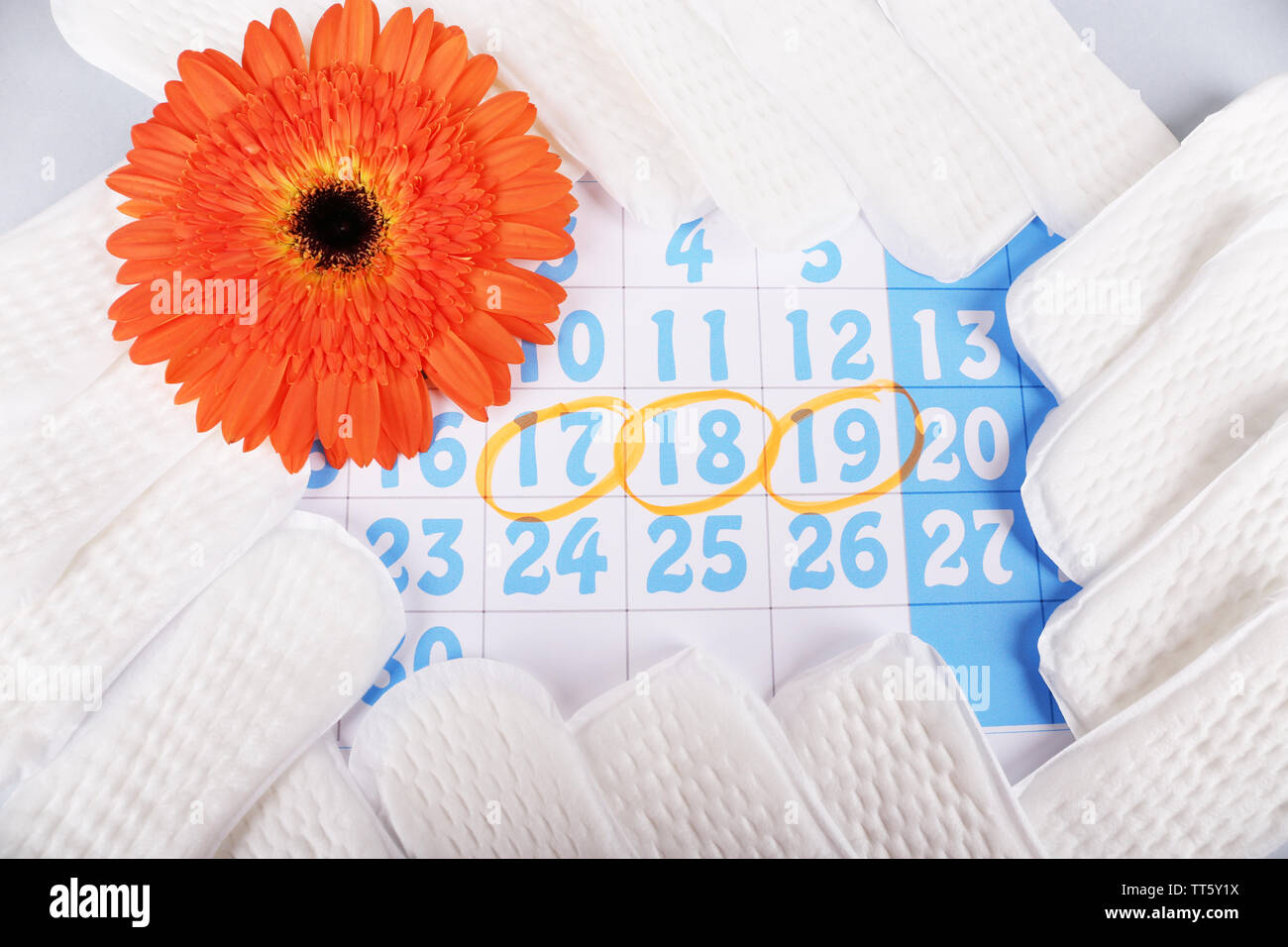 Sanitary pads, orange Gerber on blue calendar background Stock Photo ...