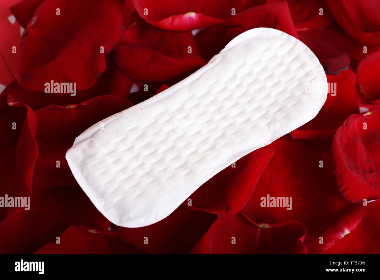 Sanitary pad on rose petals closeup Stock Photo - Alamy