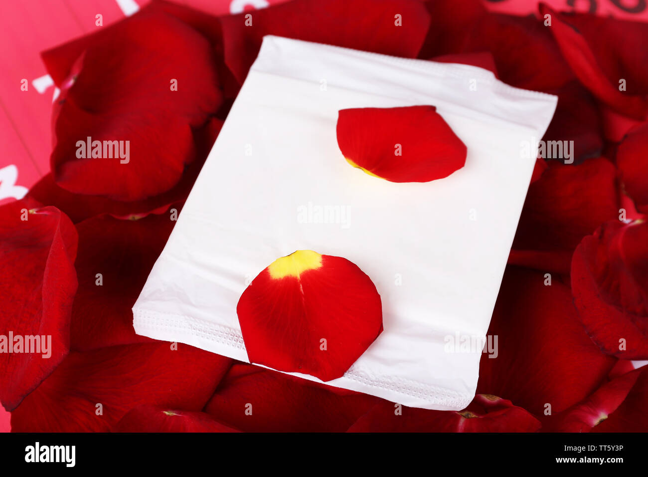 Sanitary pad on rose petals closeup Stock Photo - Alamy
