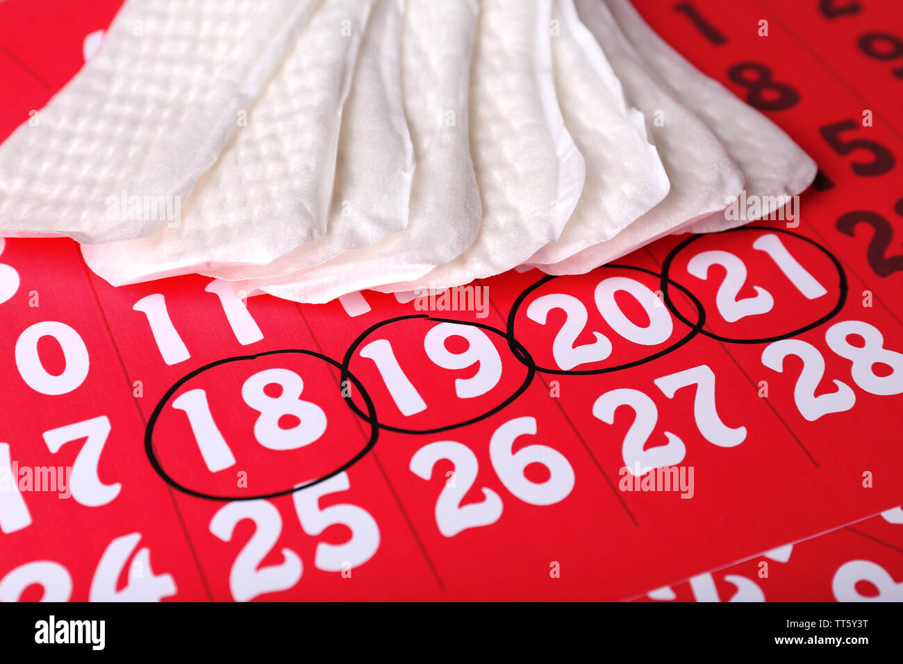 Sanitary pads on red calendar background Stock Photo - Alamy