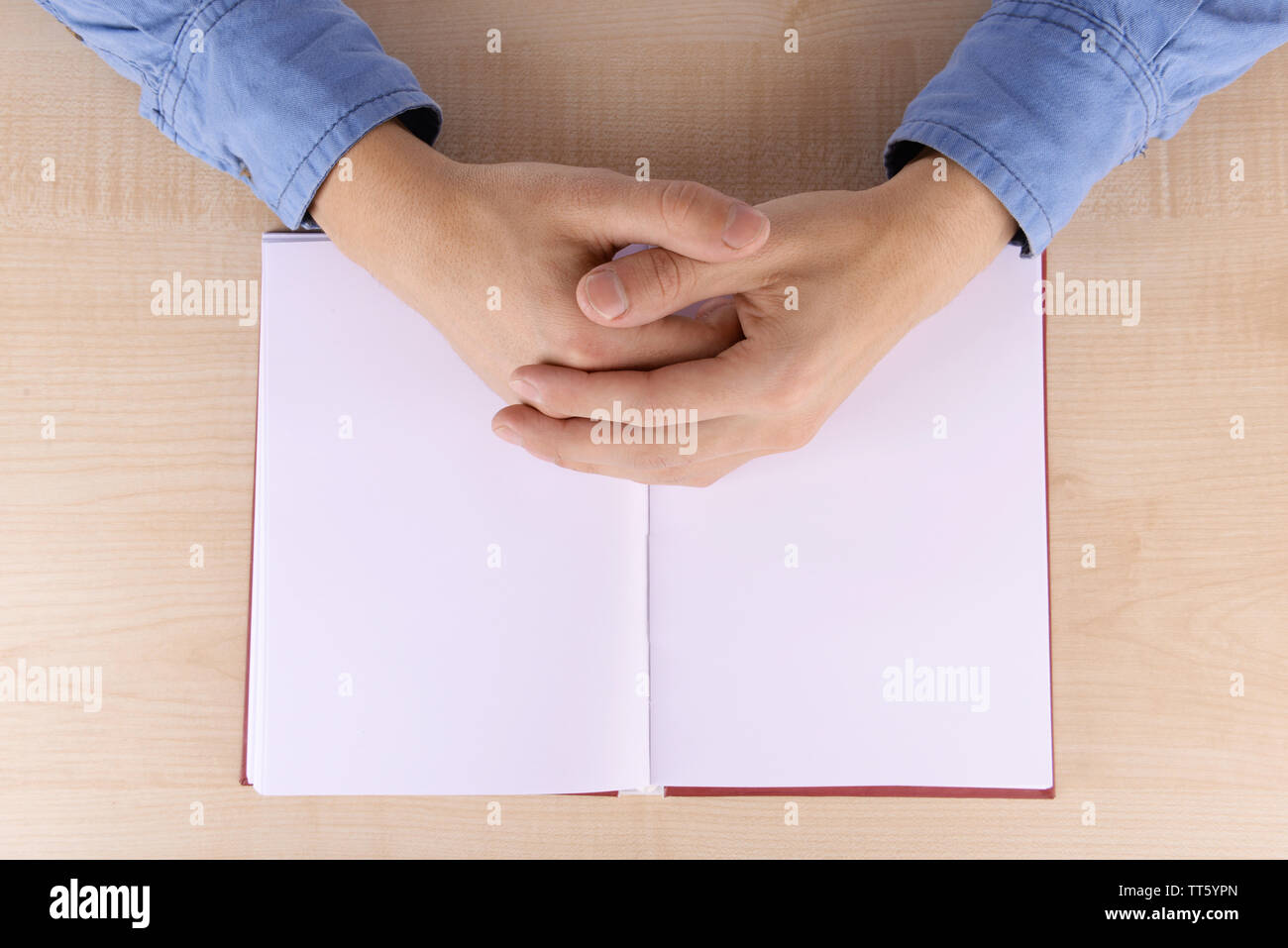 Men reading empty open book on wooden table background Stock Photo - Alamy