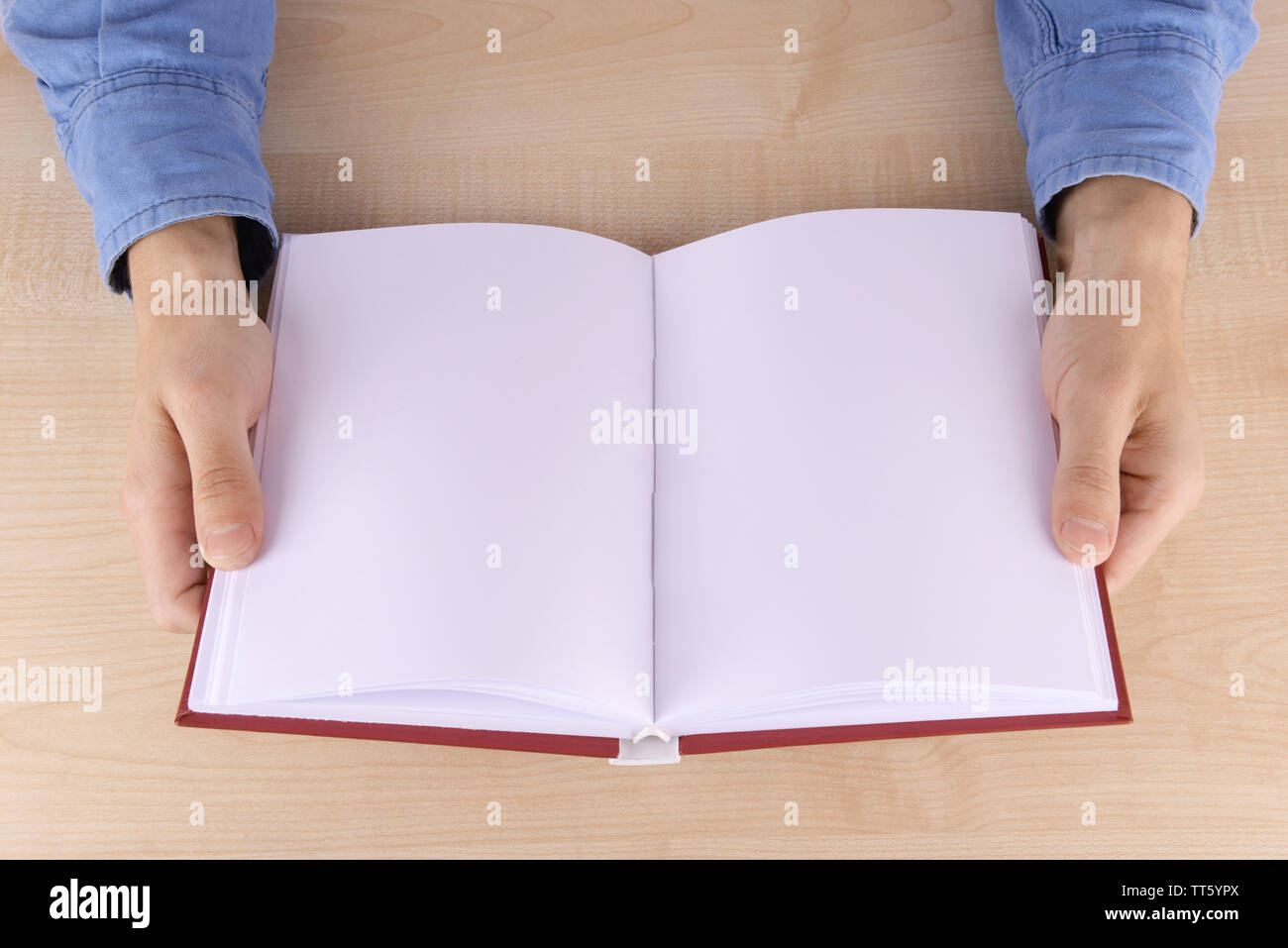 Men reading empty open book on wooden table background Stock Photo - Alamy
