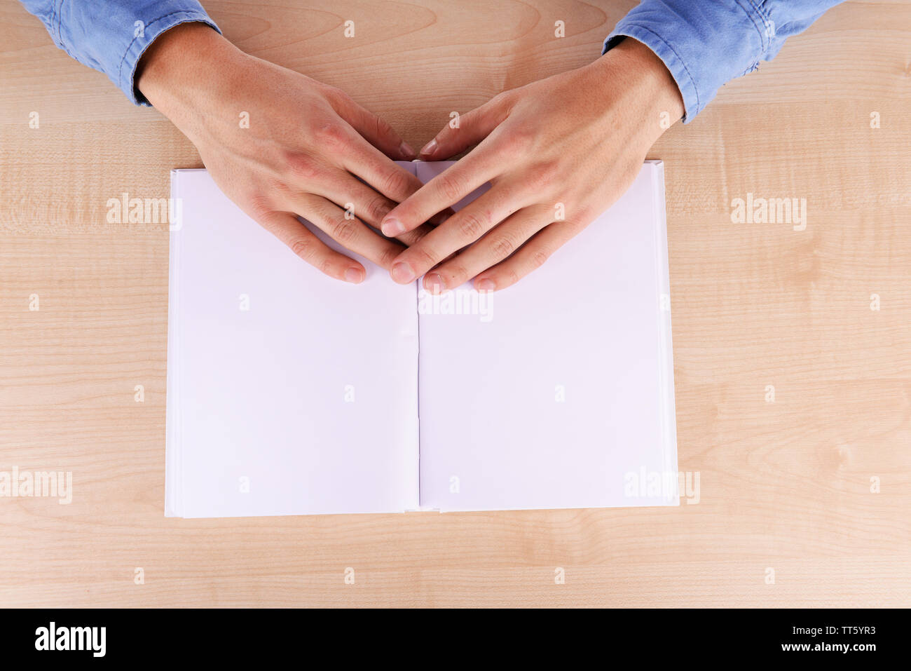 Men reading empty open book on wooden table background Stock Photo - Alamy