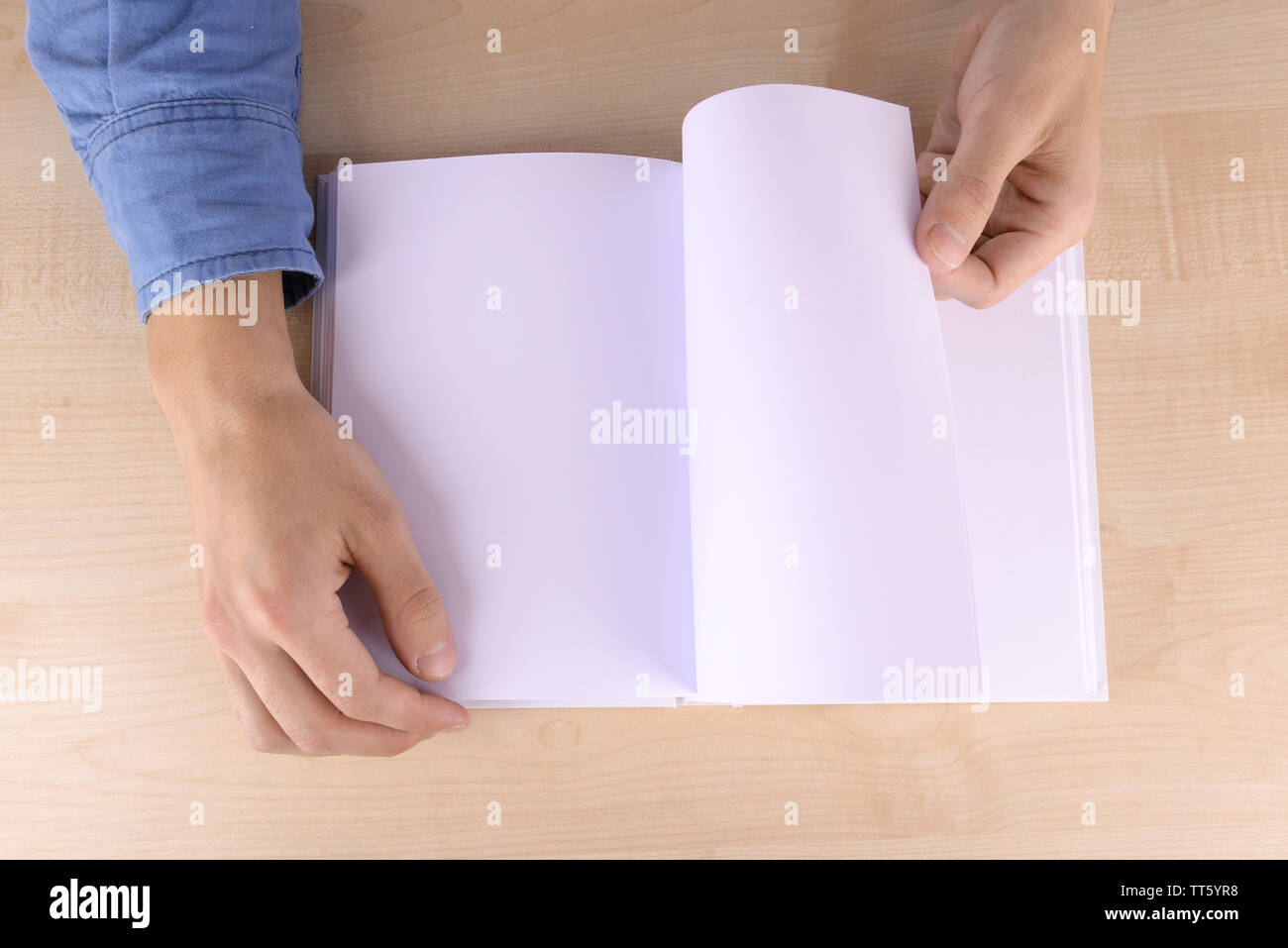 Men reading empty open book on wooden table background Stock Photo - Alamy