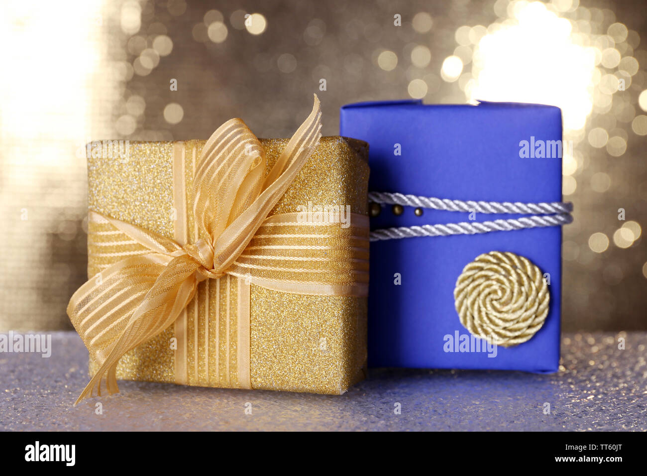 Blue and golden gift boxes on table on shiny background Stock Photo - Alamy