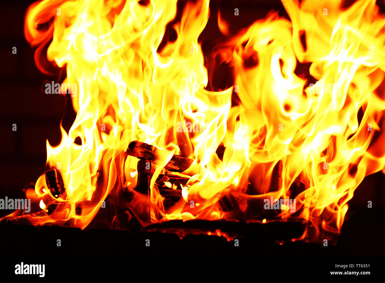 Bonfire at night on brick wall background Stock Photo - Alamy