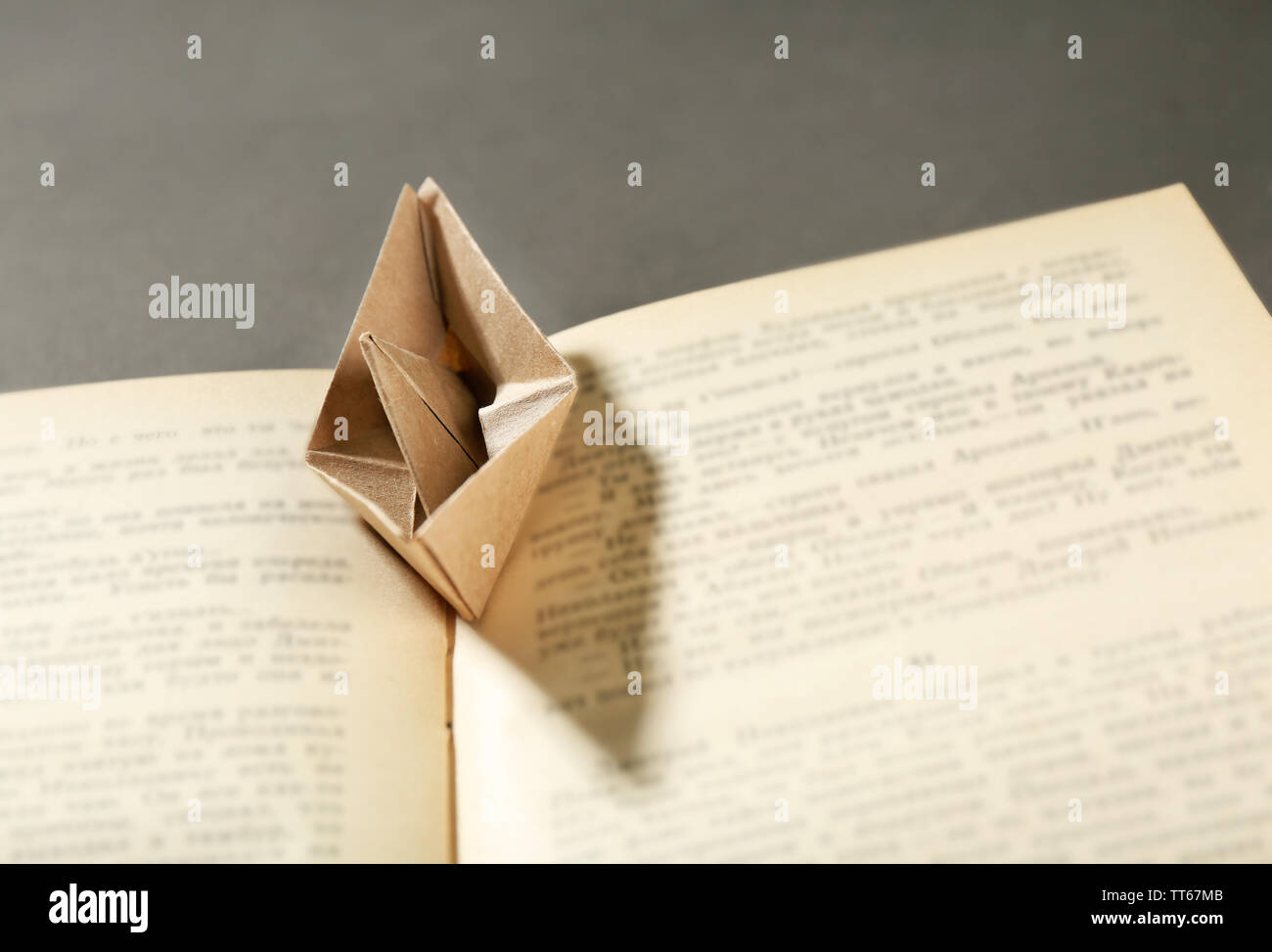 Origami boat on old book, close up Stock Photo - Alamy