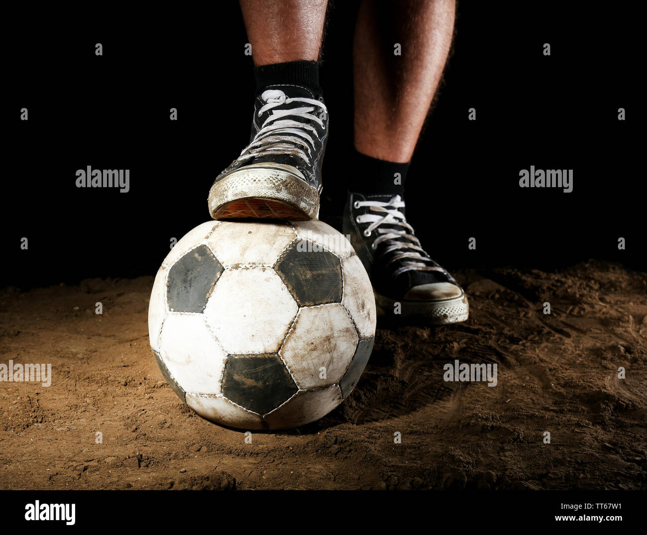 Soccer ball on ground on dark background Stock Photo - Alamy