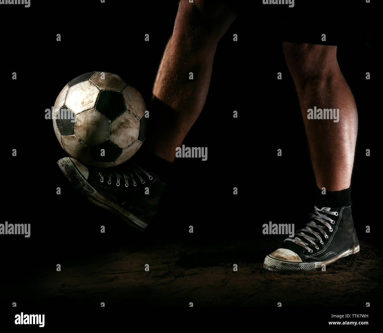 Soccer ball on ground on dark background Stock Photo - Alamy