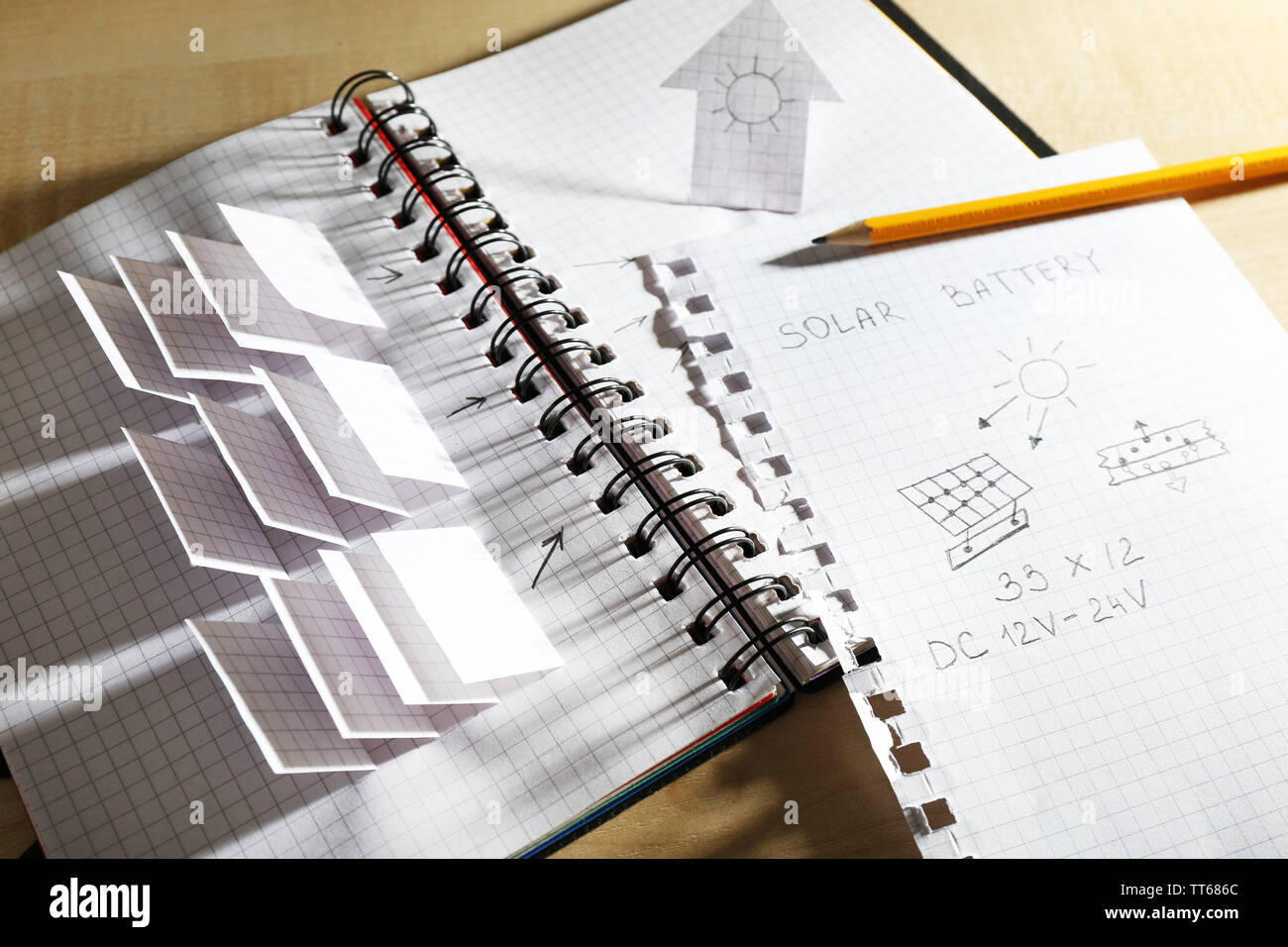 Applique paper with building and solar panels in notebook Stock Photo ...