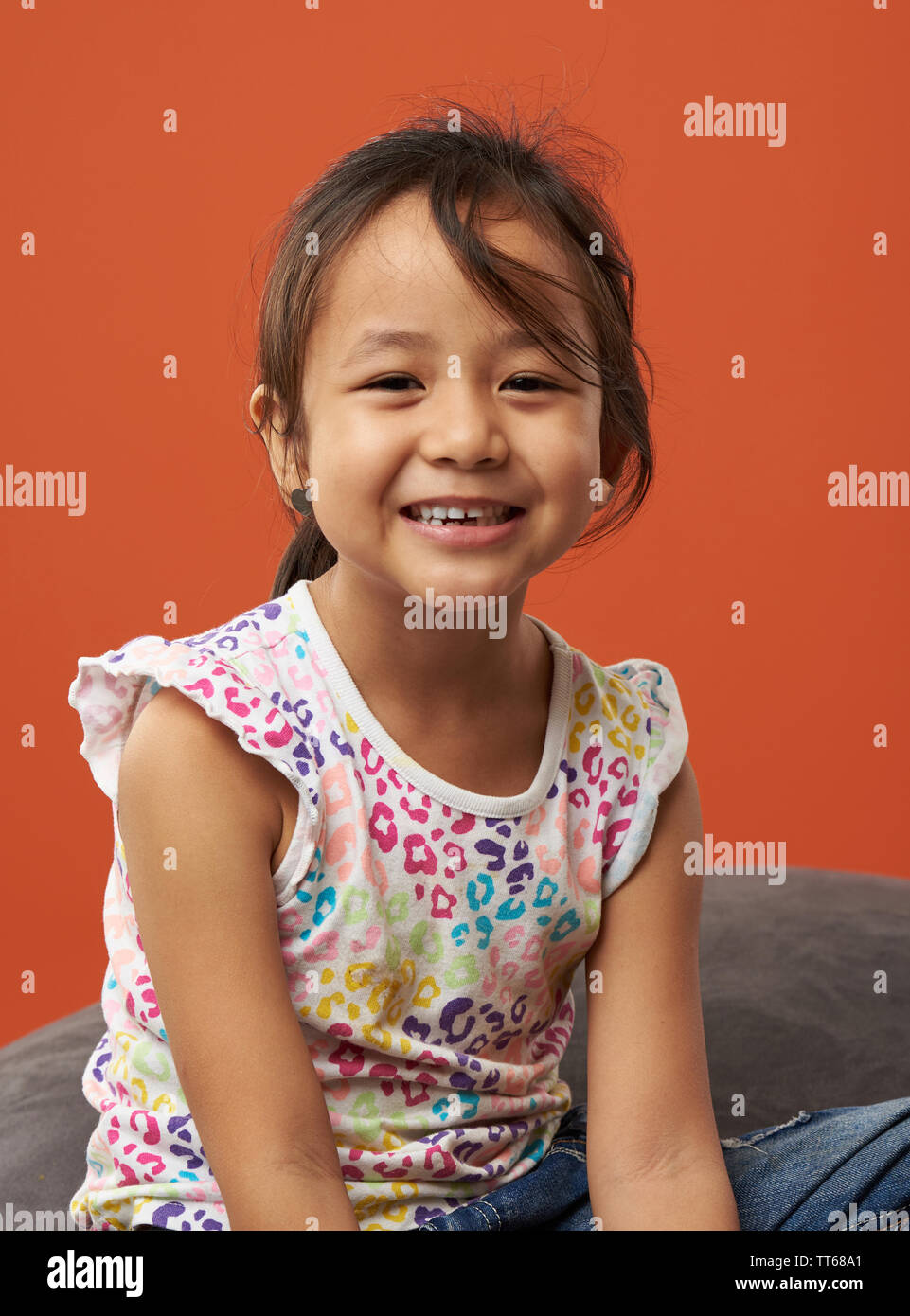 Asian kid smiling portrait. Color background Stock Photo - Alamy