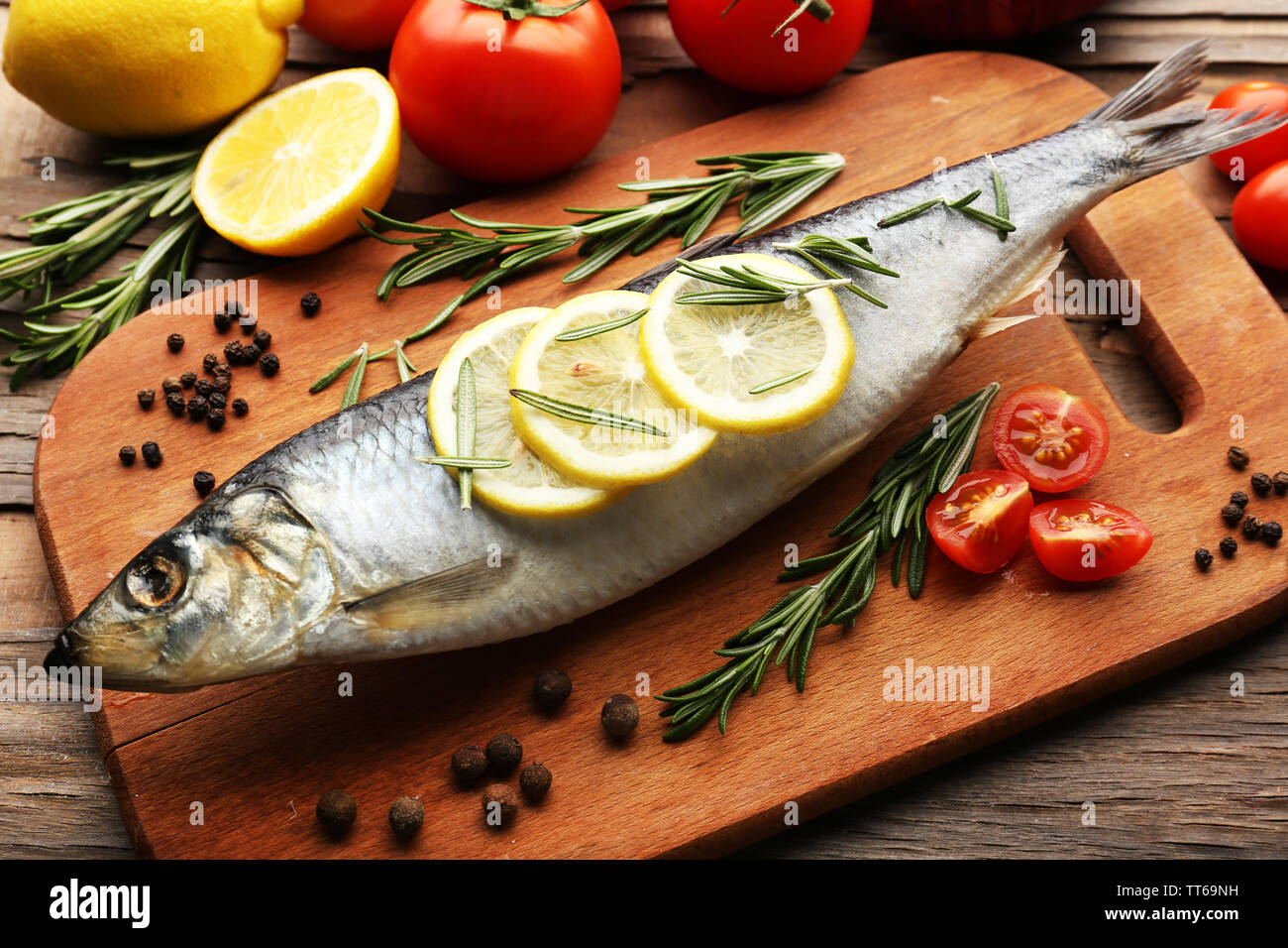 Fresh raw fish and food ingredients on table Stock Photo - Alamy