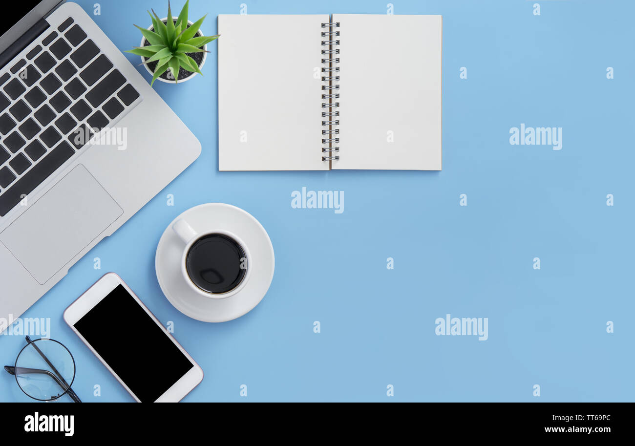 Business concept. Clean bright light blue office table desk, minimal ...