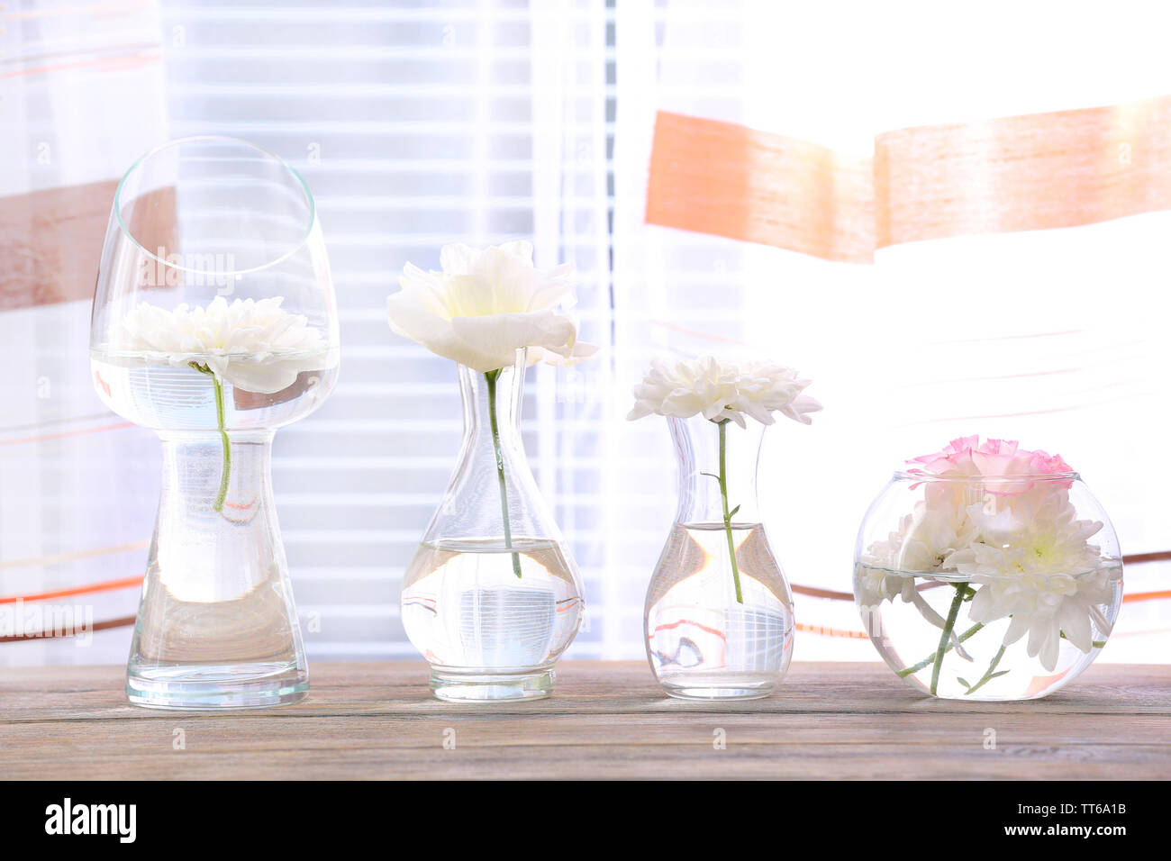 Beautiful flowers in vases with light from window Stock Photo - Alamy