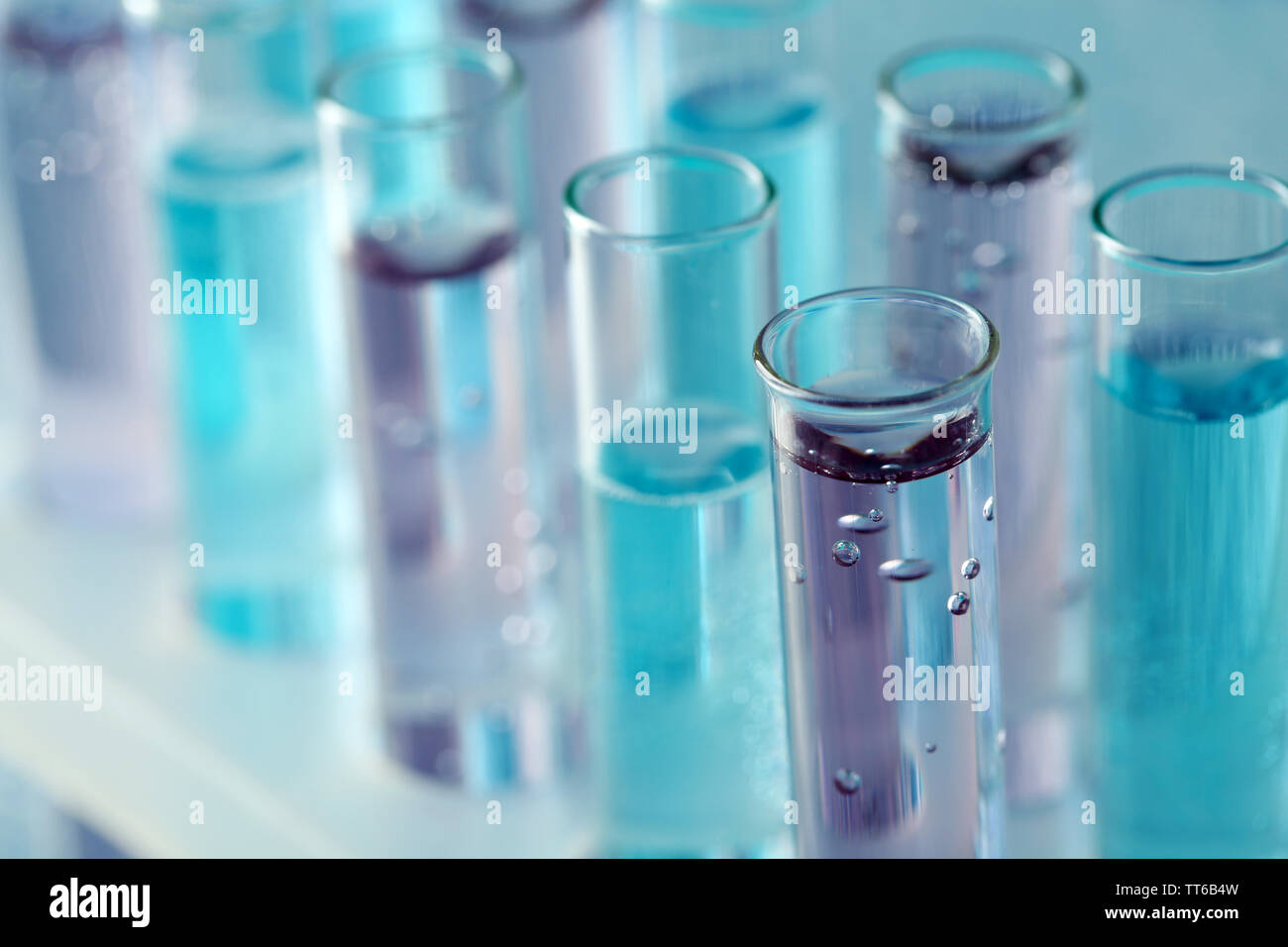 Test-tubes with liquid on color background Stock Photo - Alamy