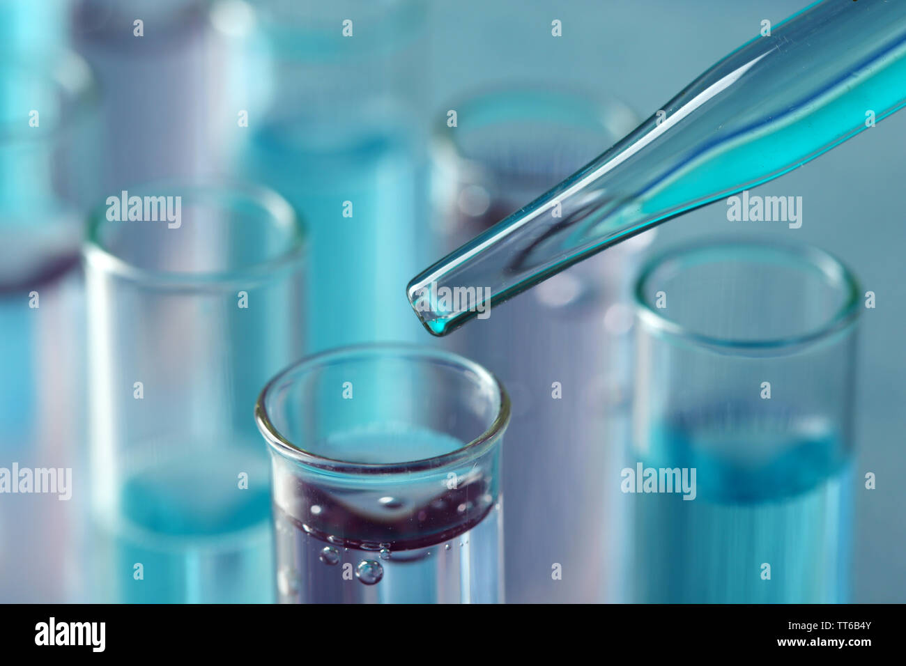 Test-tubes with liquid on color background. Drops from test stick Stock ...